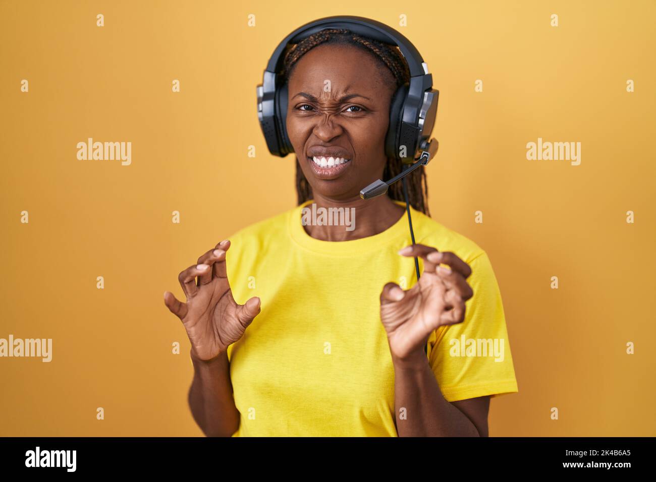 African american woman listening to music using headphones disgusted ...