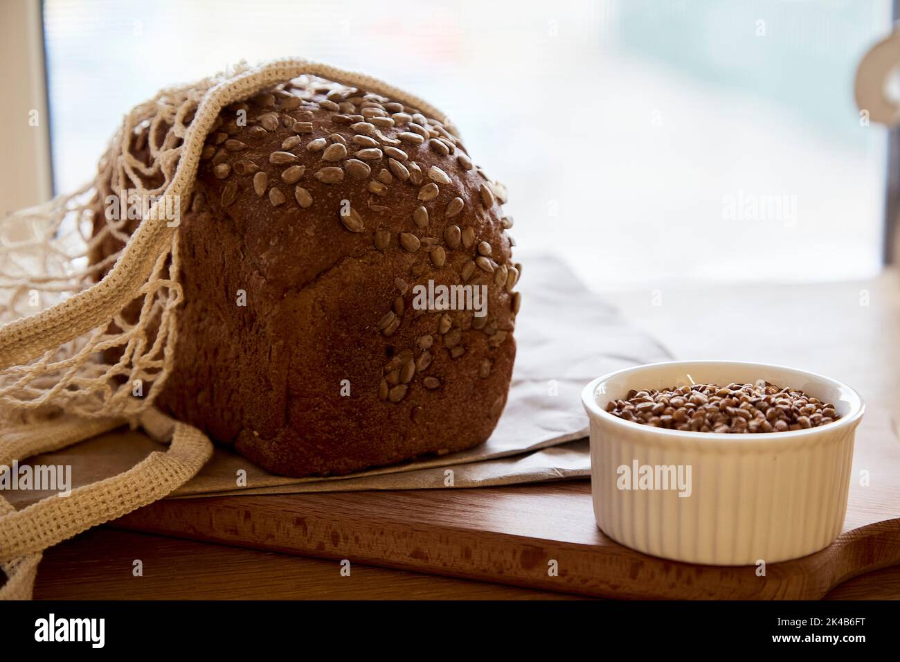 Fresh buckwheat bread with sunflower seeds in eco mesh. Natural ...