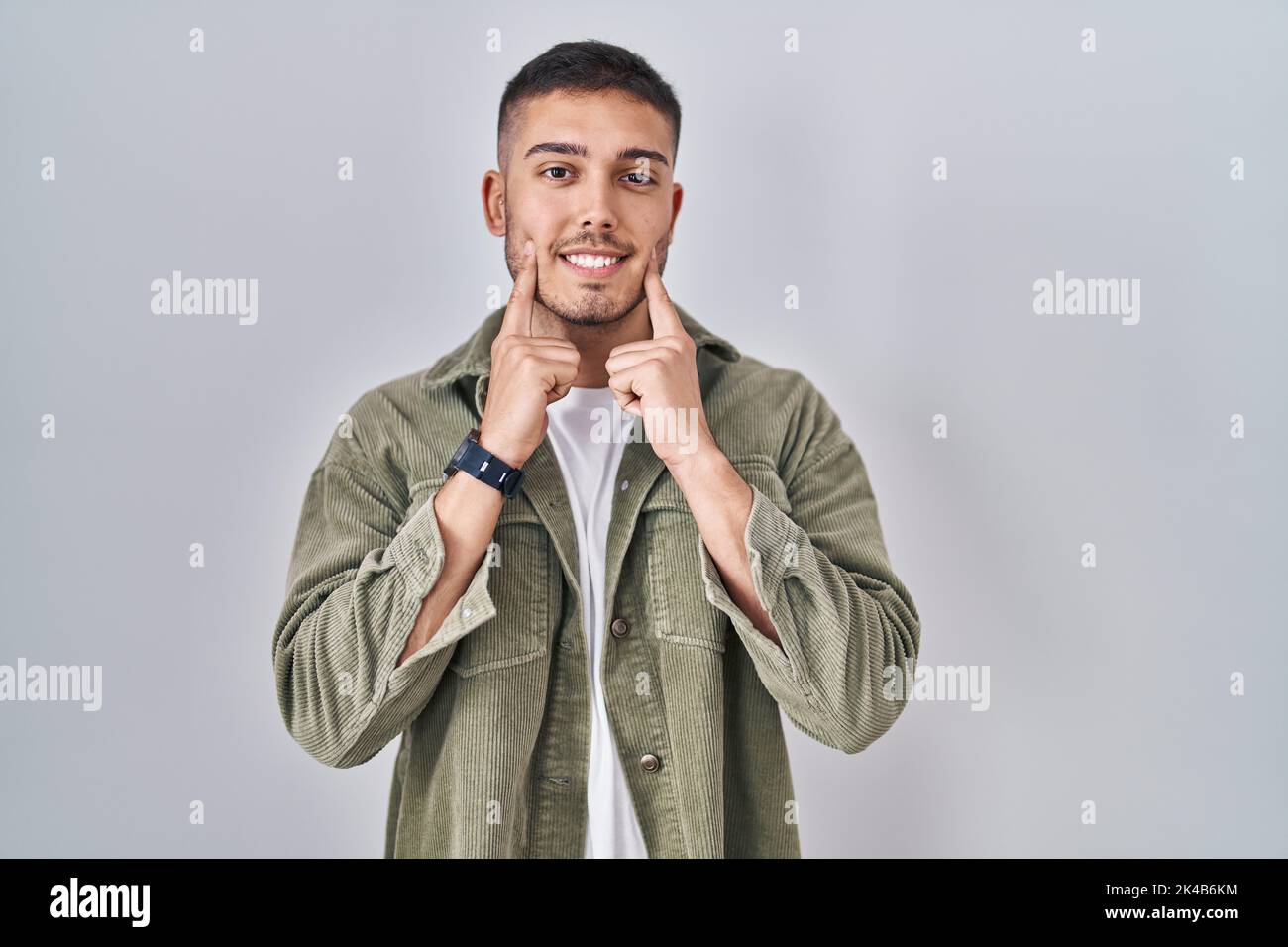 Young hispanic man standing over isolated background smiling with open ...