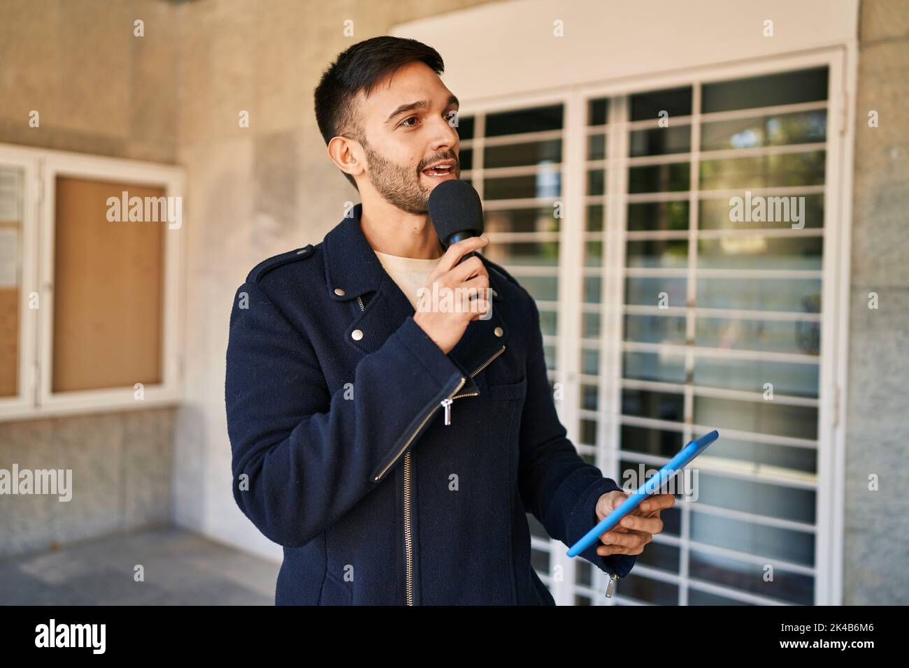 Young hispanic man reporter working using microphone and touchpad at street Stock Photo - Alamy