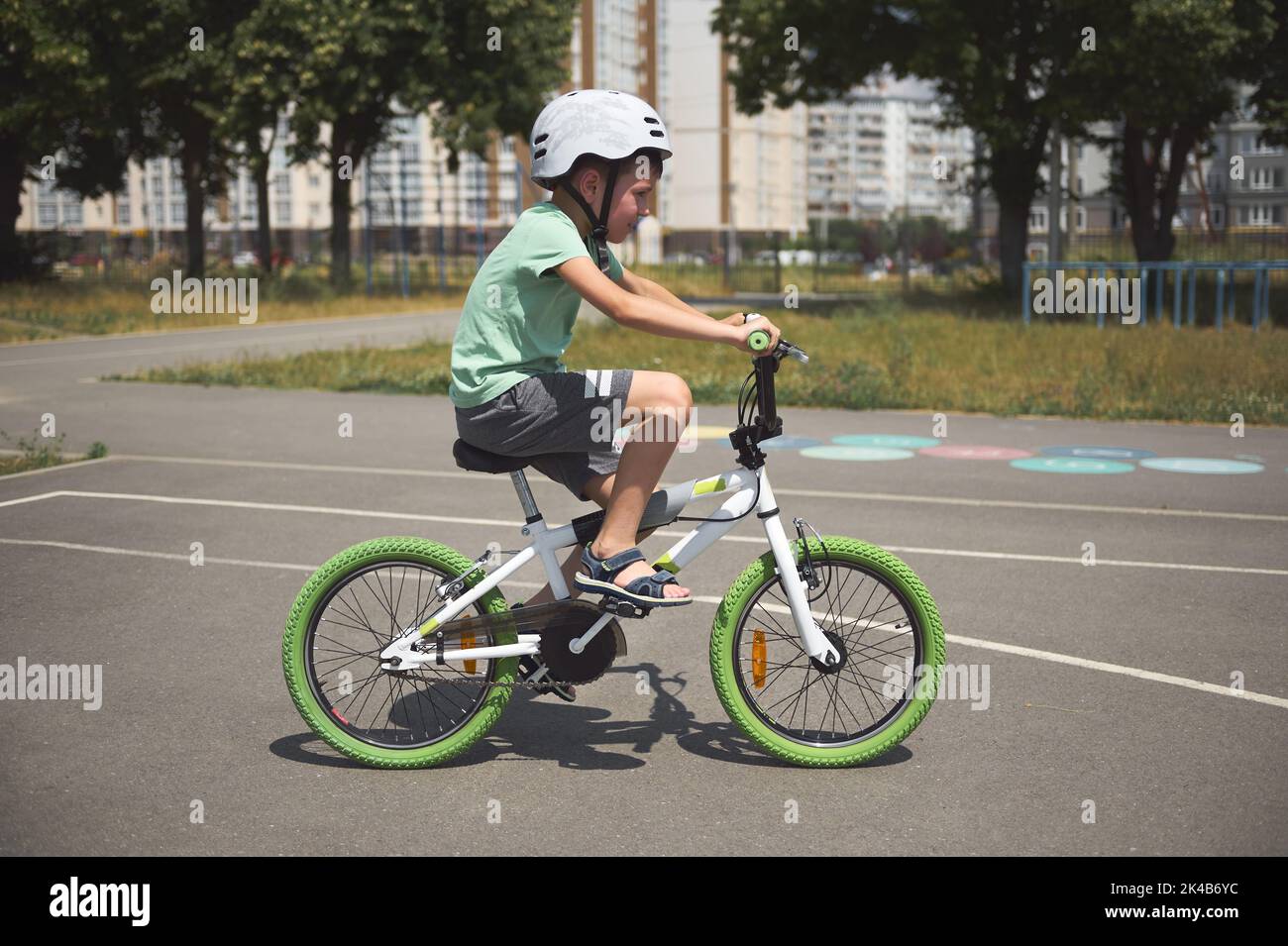 Caucasian child boy, athletic cyclist, wearing active wear and safety ...