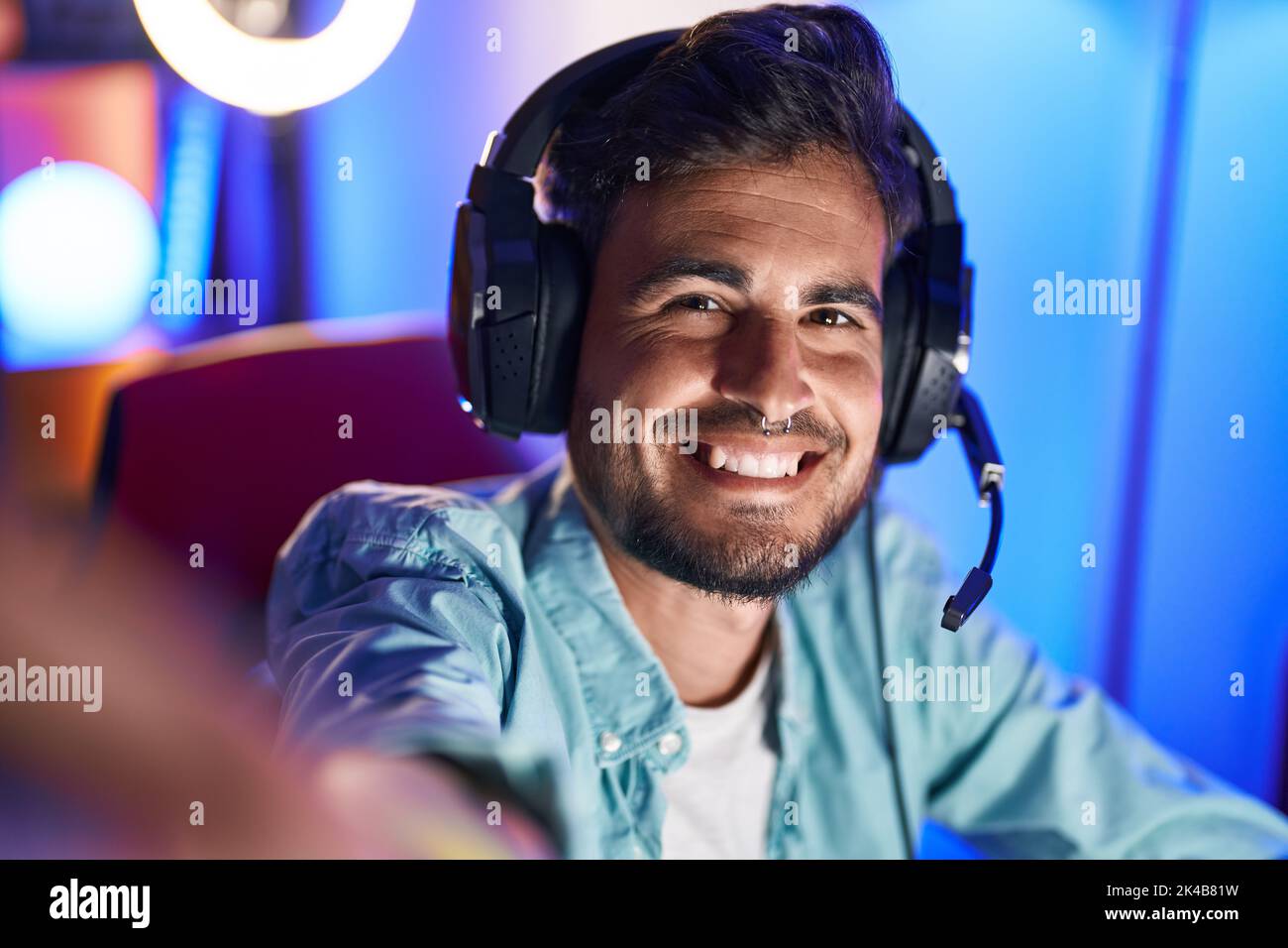 Young hispanic man streamer smiling confident make selfie by camera at ...