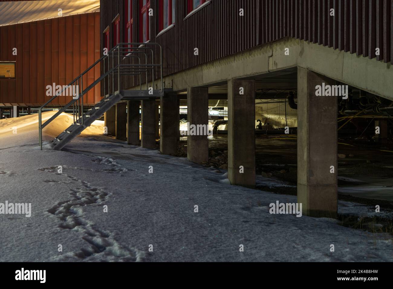 Svalbard University Science Centre at night on raised stilts permafrost ...