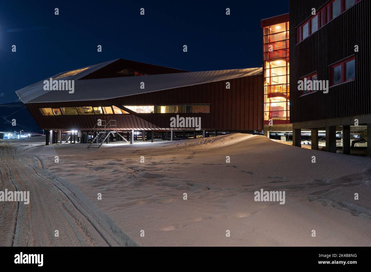 Svalbard University Science Centre at night on raised stilts permafrost ...