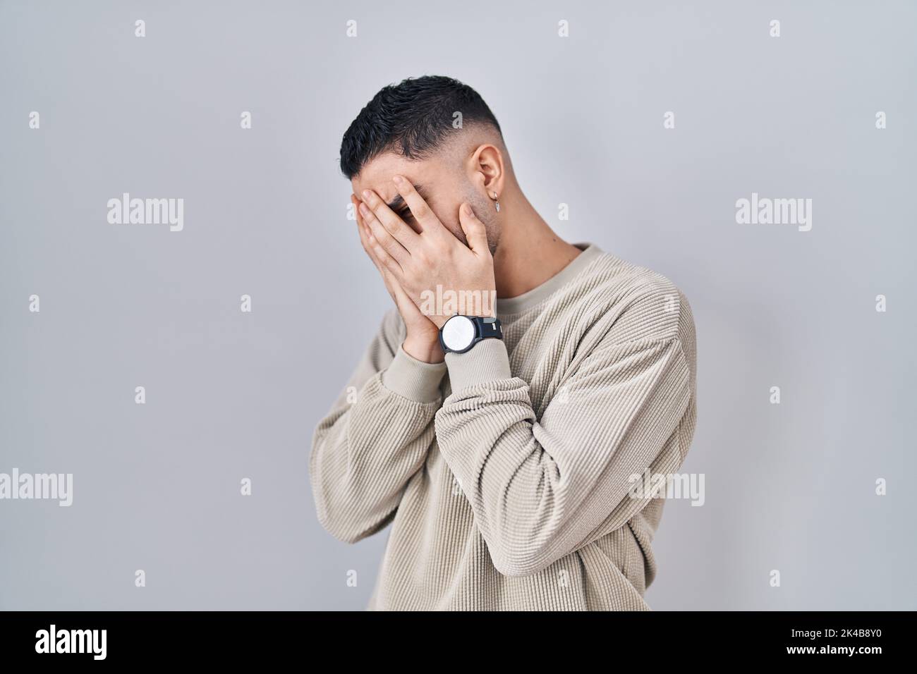 Young handsome man standing over isolated background with sad ...