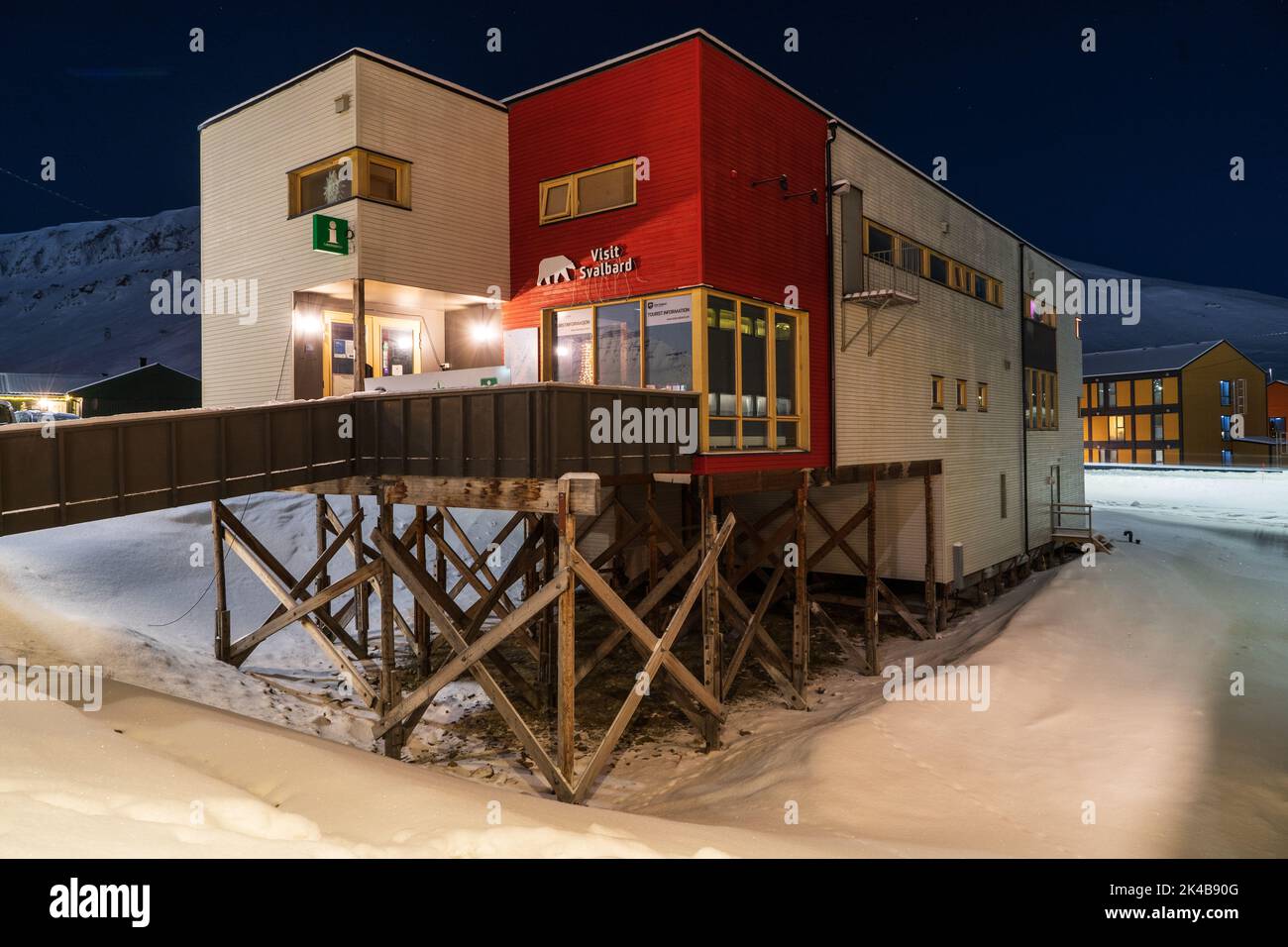 Visit Svalbard headquarters building raised on stilts at night in snow ...