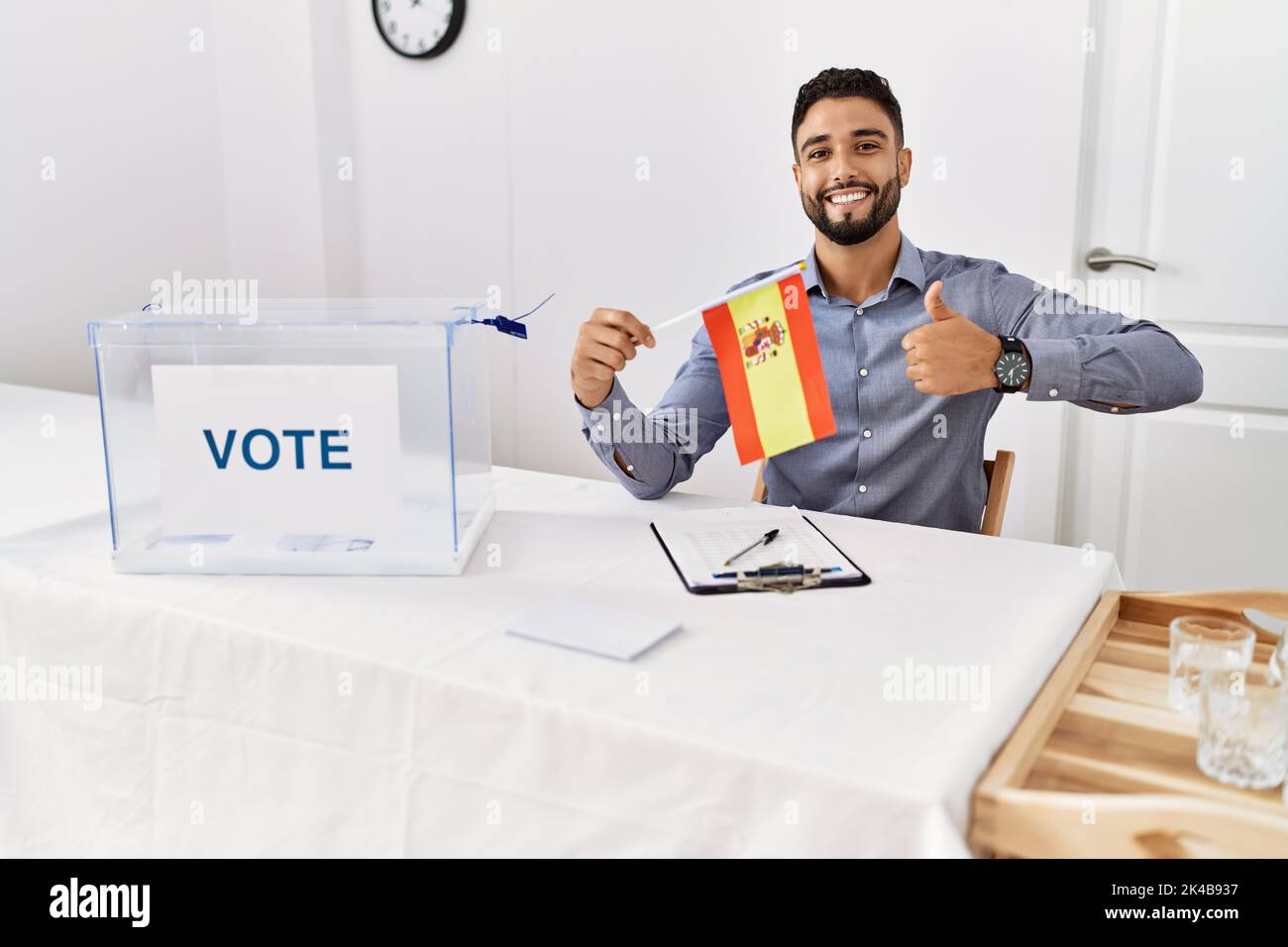 Young handsome man with beard at political campaign election holding ...