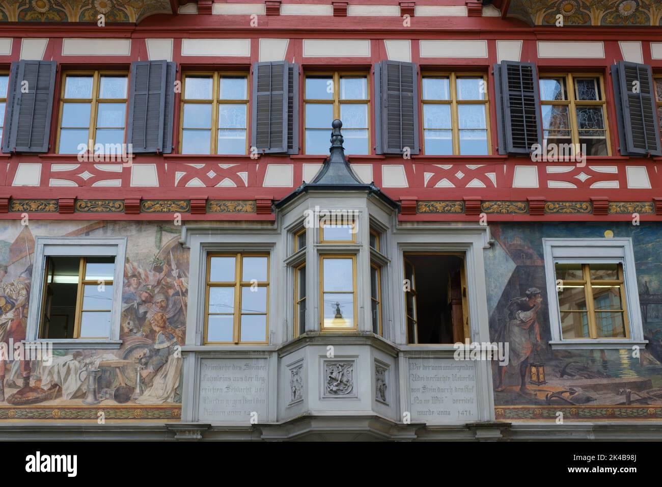 Bay window on painted facade, Historic House on Town Hall Square ...