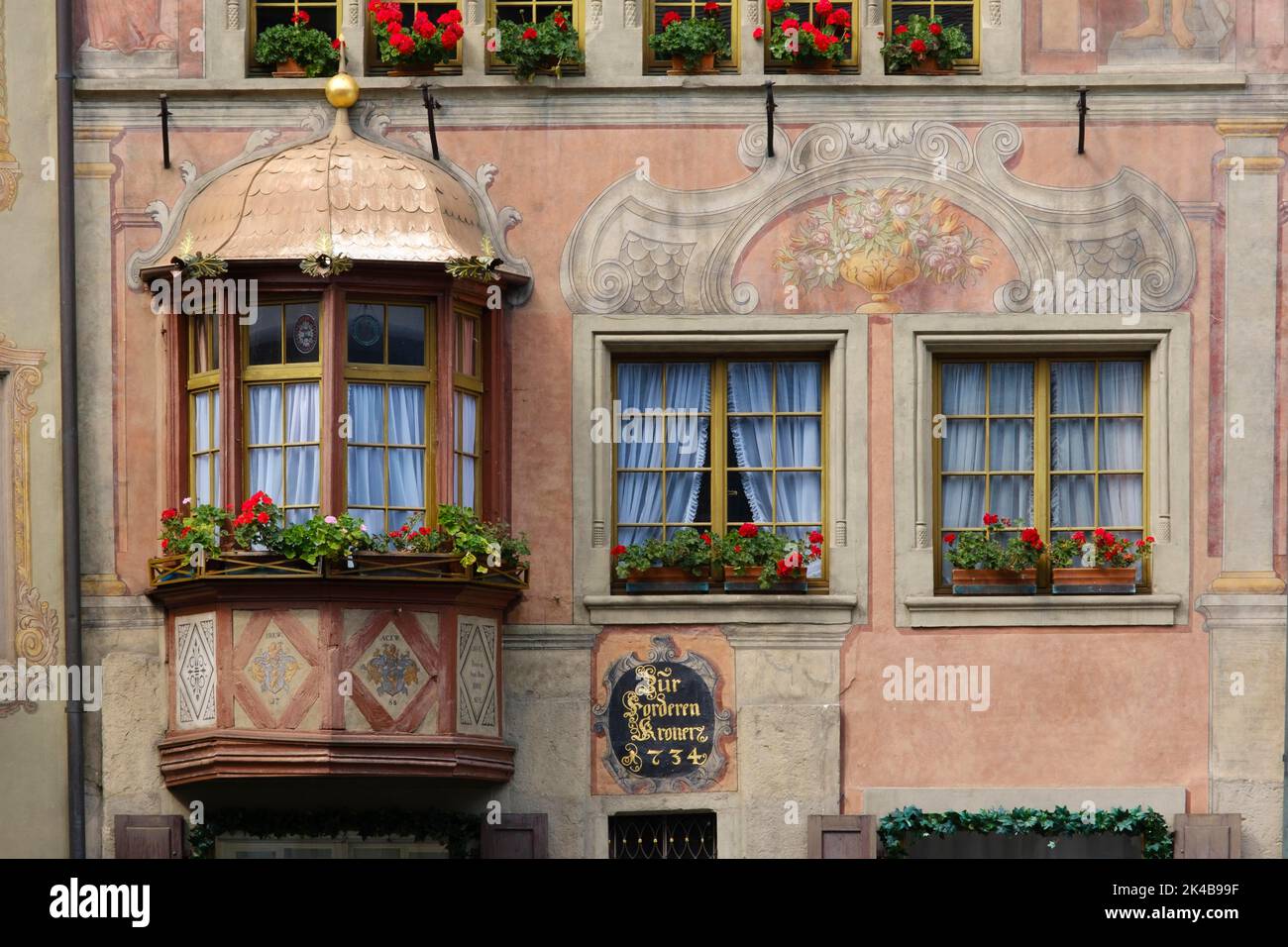 Bay window on painted facade, Historic House on Town Hall Square ...