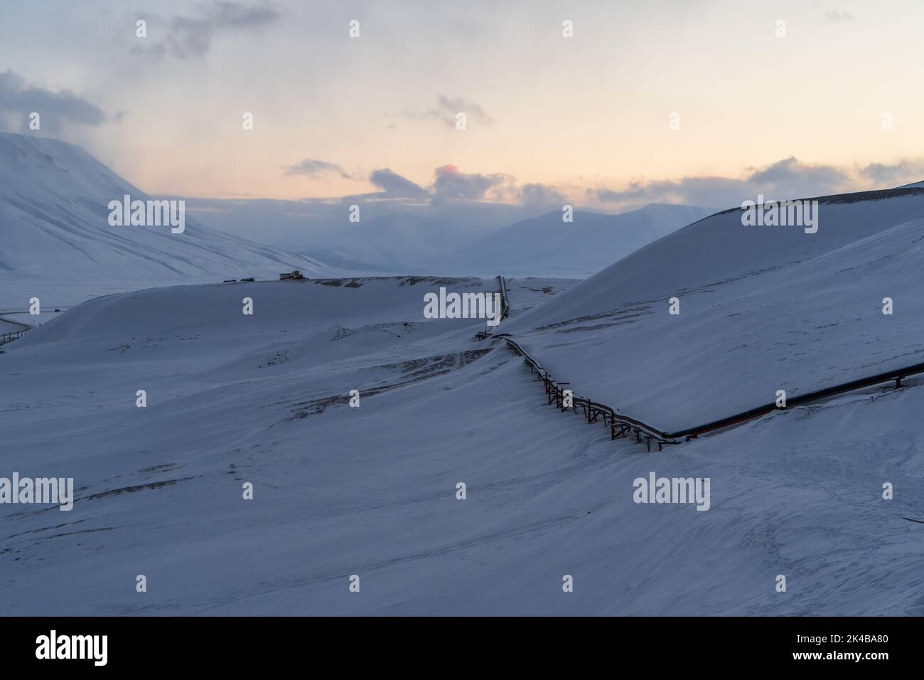 Raised pipelines through snowy Svalbard landscape, Longyearbyen Stock ...