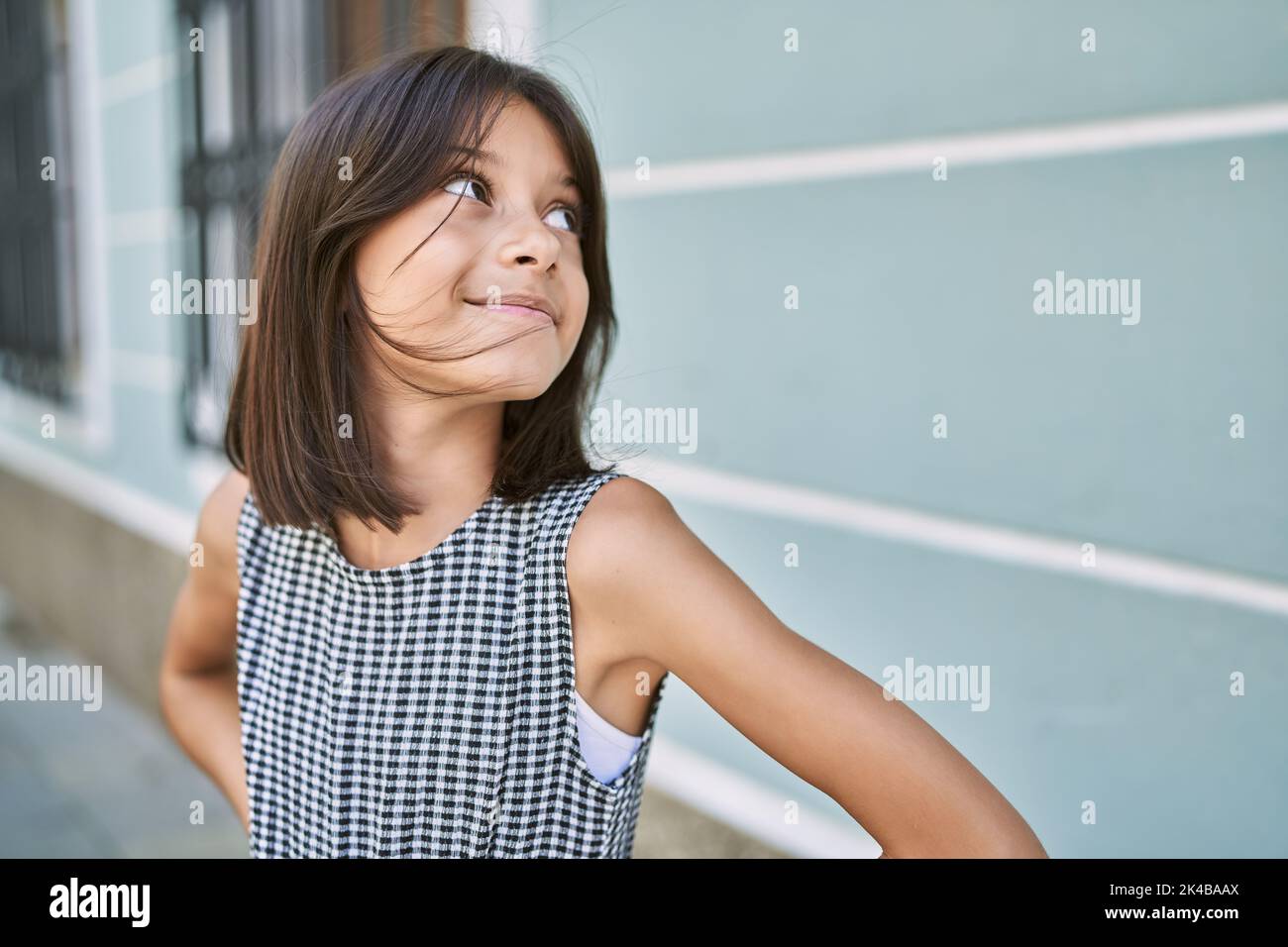 Young hispanic girl smiling outdoor at the town Stock Photo - Alamy