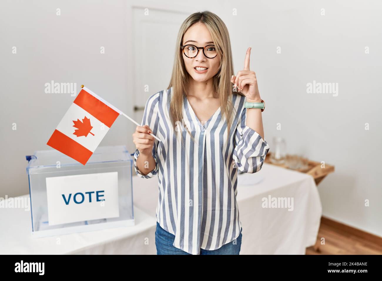 Asian young woman at political campaign election holding canada flag ...