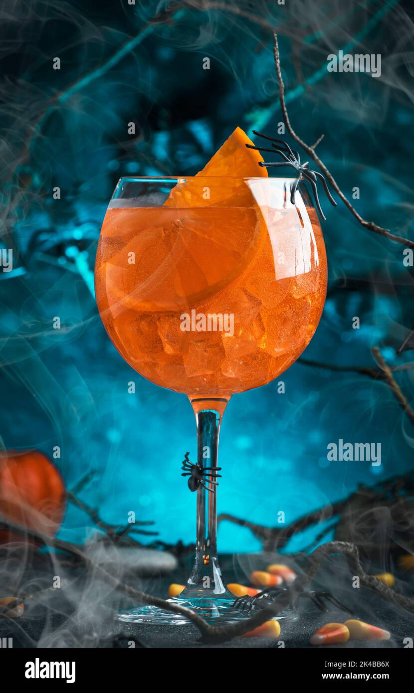 Halloween aperol spritz cocktail on scary dark blue background with ...