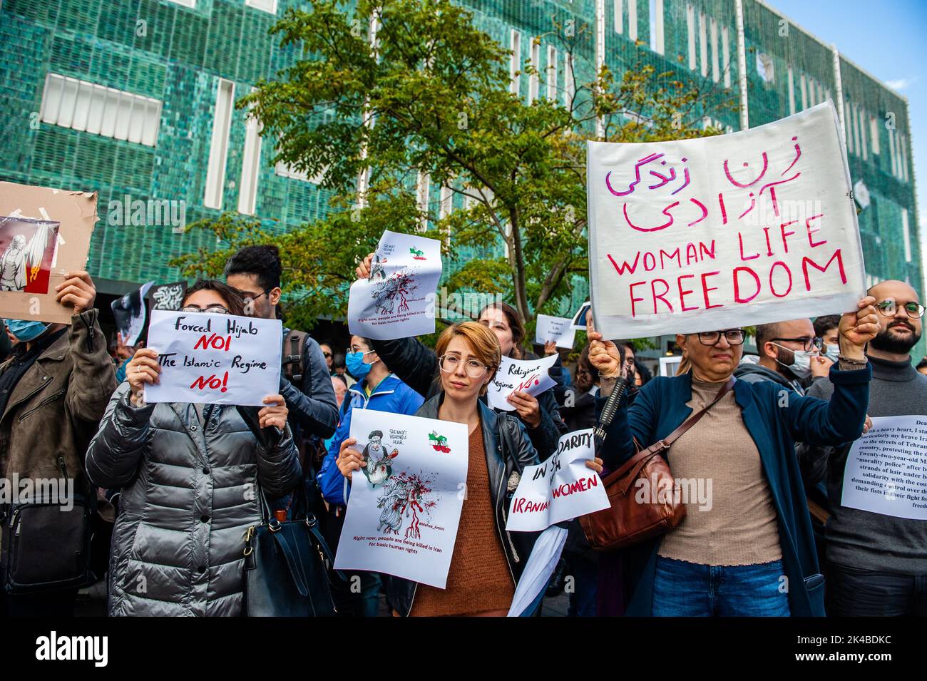 Iranian people are seen holding placards in support of women freedom ...