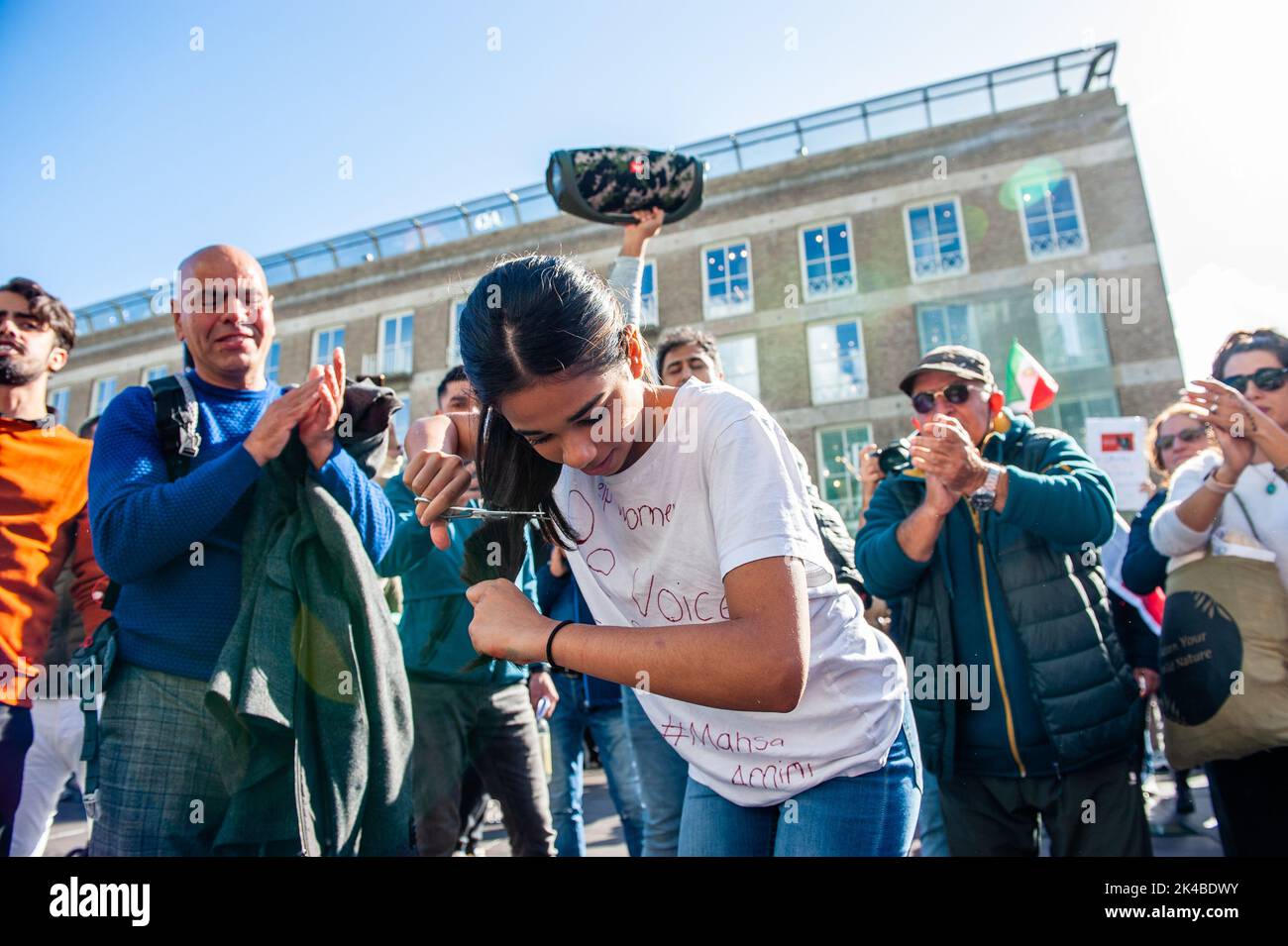 An Iranian woman is seen cutting off her hair during the demonstration ...