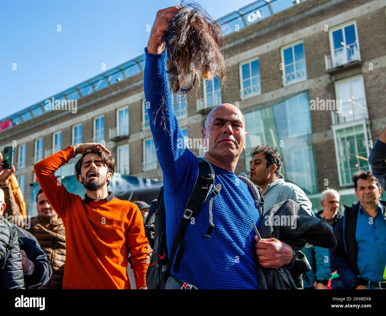 An Iranian man is seen holding cut hair belonging to the Iranian women ...
