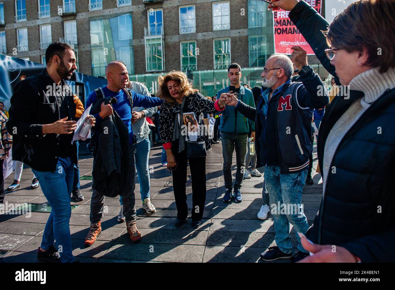 An Iranian woman is seen deeply pained after cutting off her hair ...