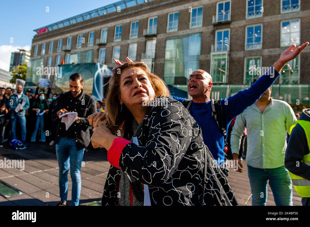 An Iranian woman is seen cutting off her hair during the demonstration ...