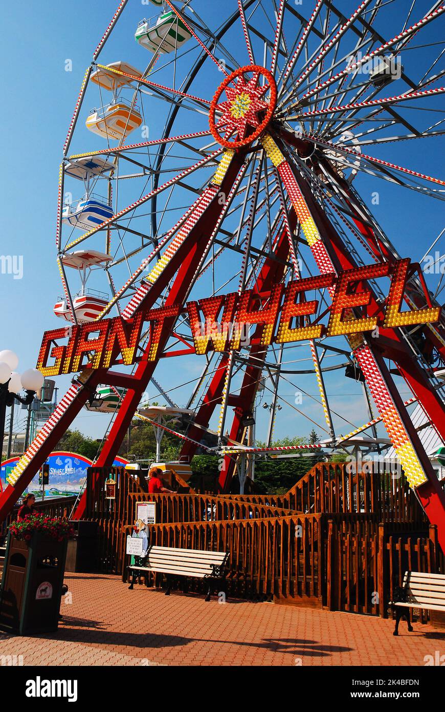 A giant Ferris wheel is ready to take riders on a fun trip over an ...