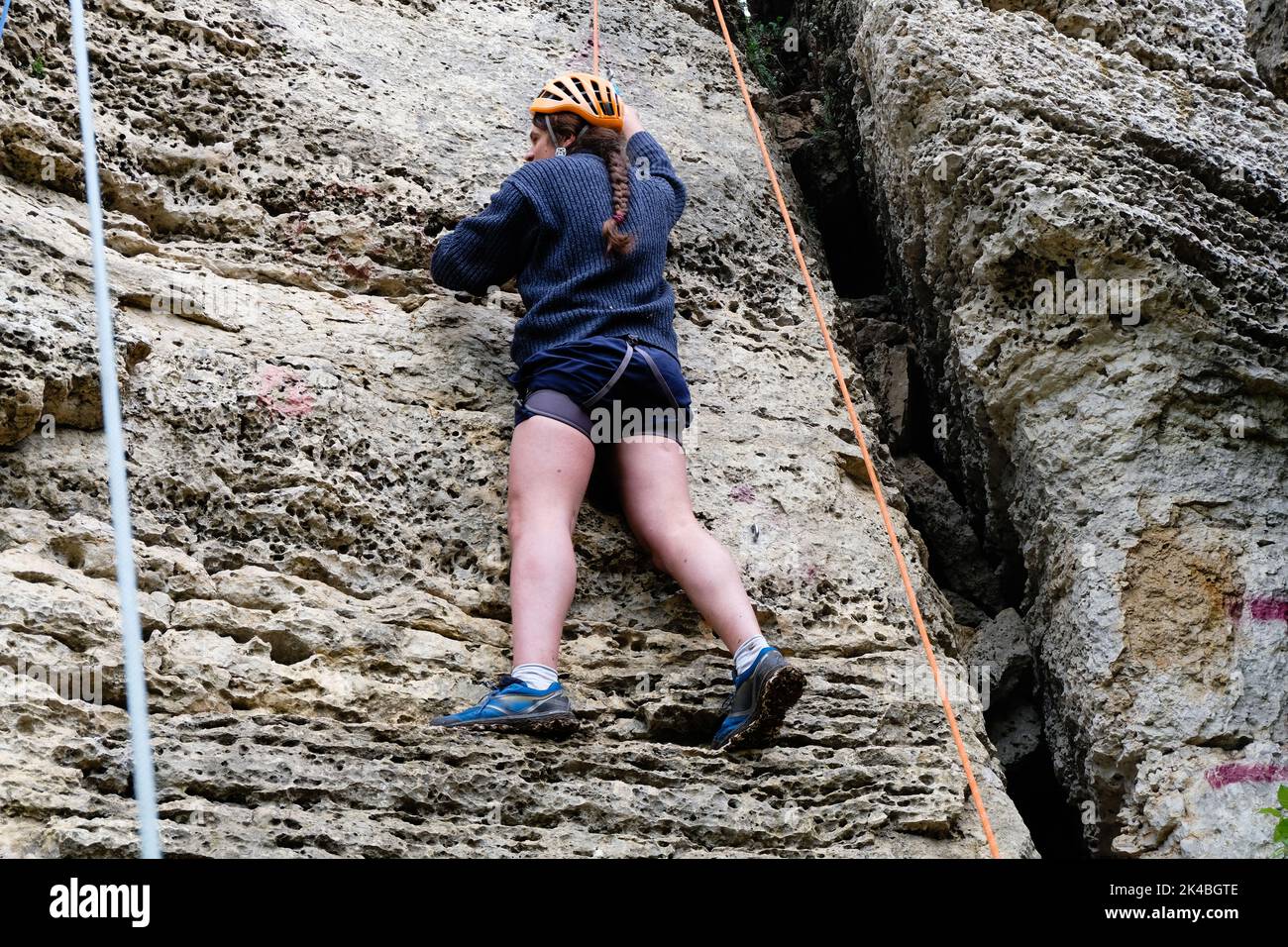 Man in helmet climbing on a rock. Rock climber training Stock Photo - Alamy