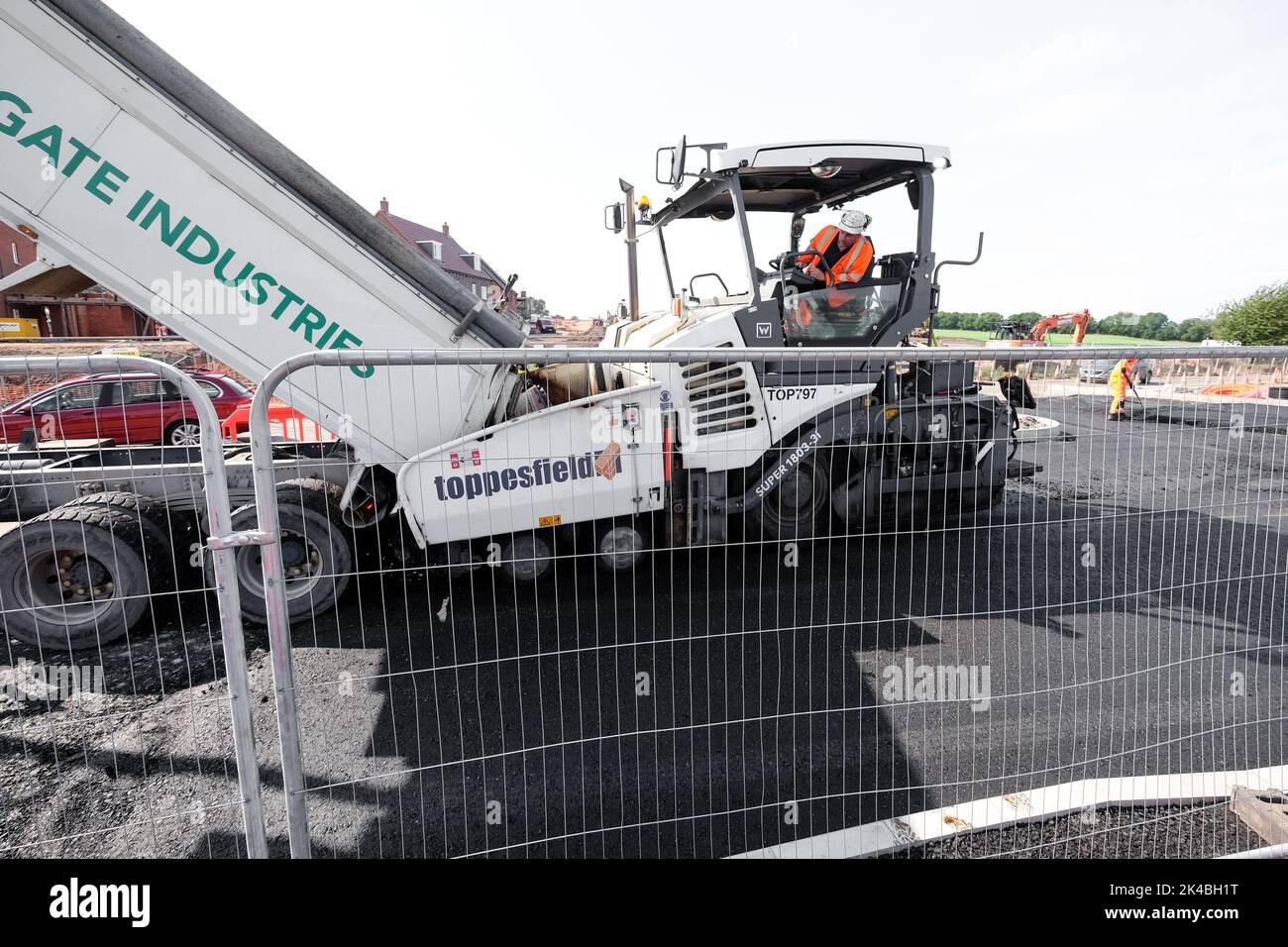 asphalt paver laying tarmac on a new road Stock Photo - Alamy