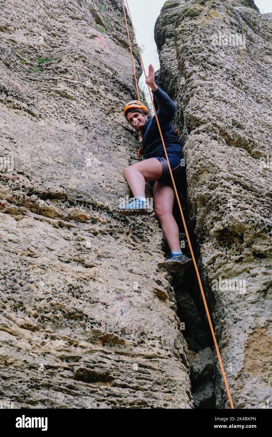 Man in helmet climbing on a rock. Rock climber training Stock Photo - Alamy