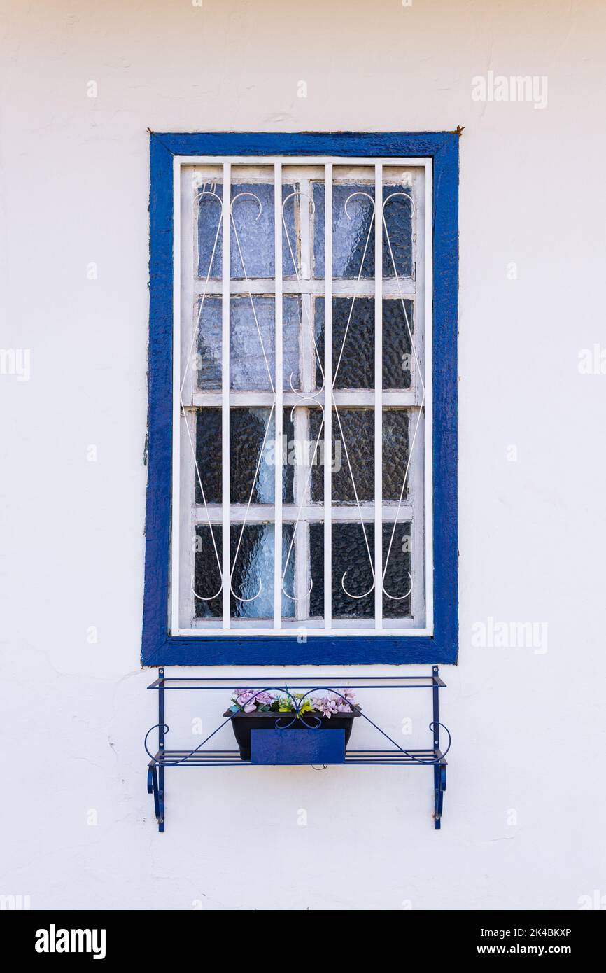 Window with white wood panels with cobalt blue trim in Sabará, Minas ...