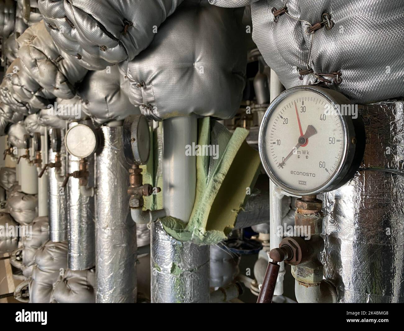 A closeup shot of gauge and pipes in the boiler room of a hospital ...