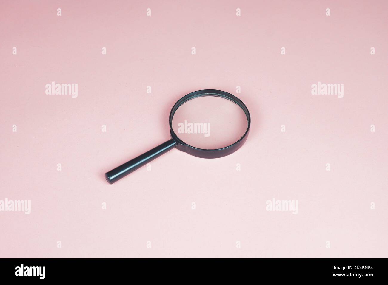 Magnifying glass on the pink background. Magnifier top view. Loupe as a ...