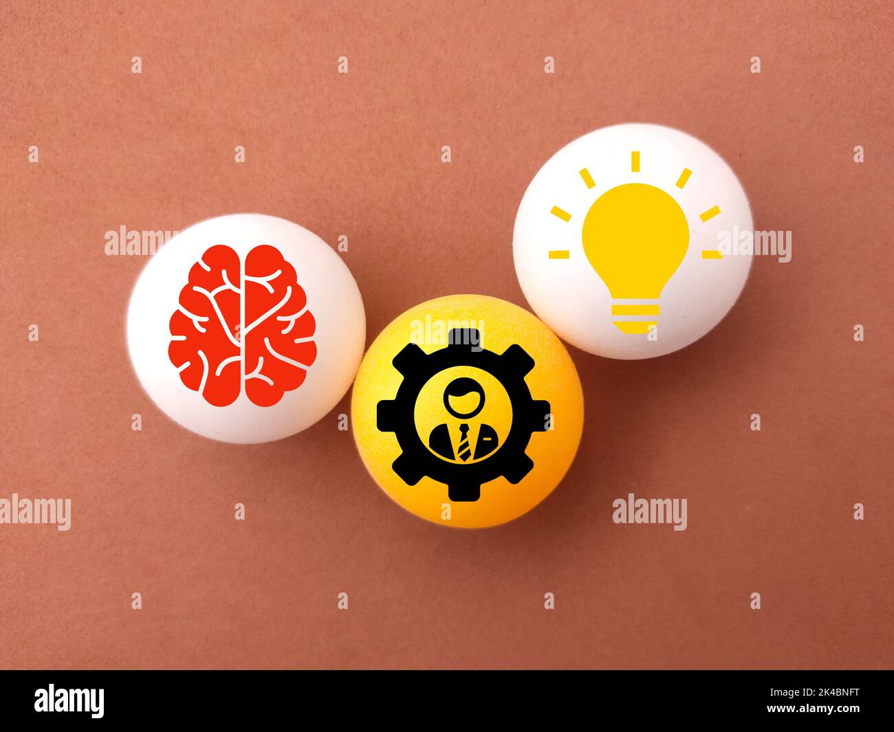 A Ping pong ball with idea and brain icons Stock Photo - Alamy