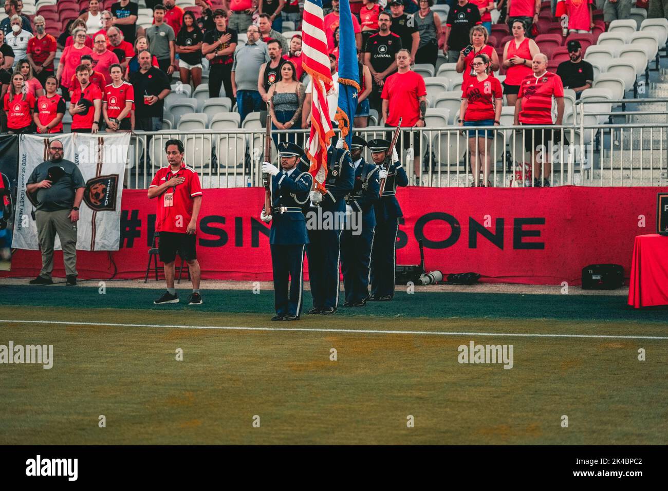 Troops marching with flags in a stadium at a football game Stock Photo ...