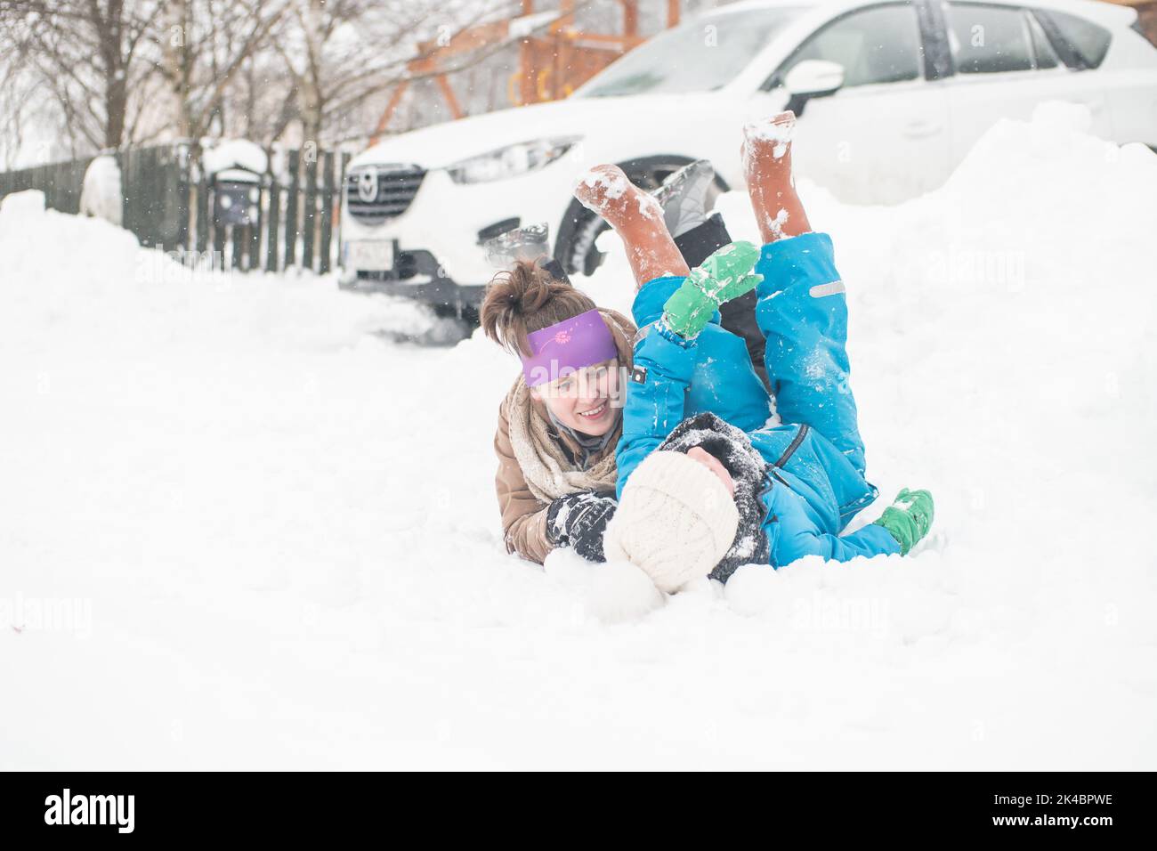 Mother and child, boy have funny time in the winter season full of snow ...