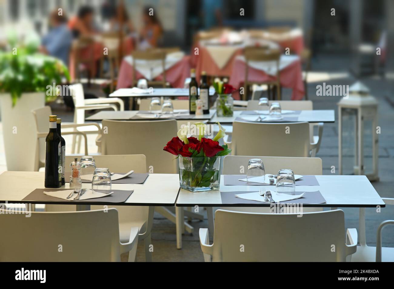 The empty restaurant tables set in the terrace waiting customers for ...