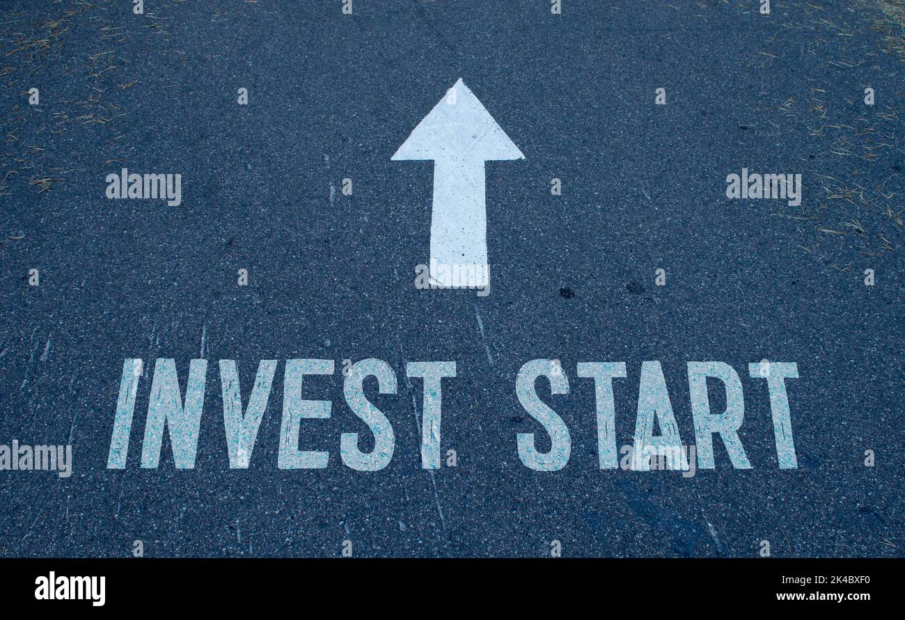 Business concept. On the asphalt road markings an arrow with the ...