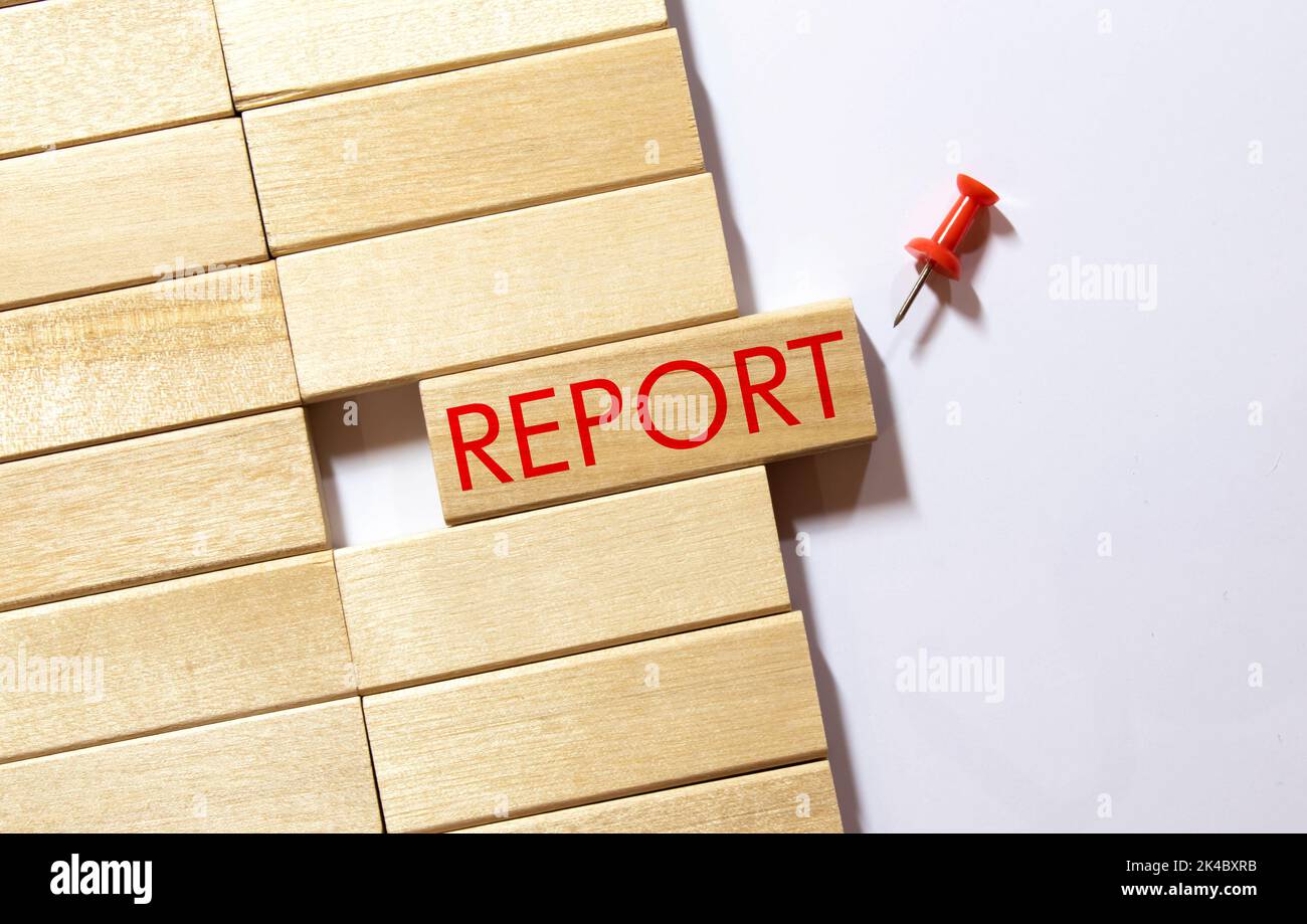 The word report on wooden blocks against paper files and folders ...
