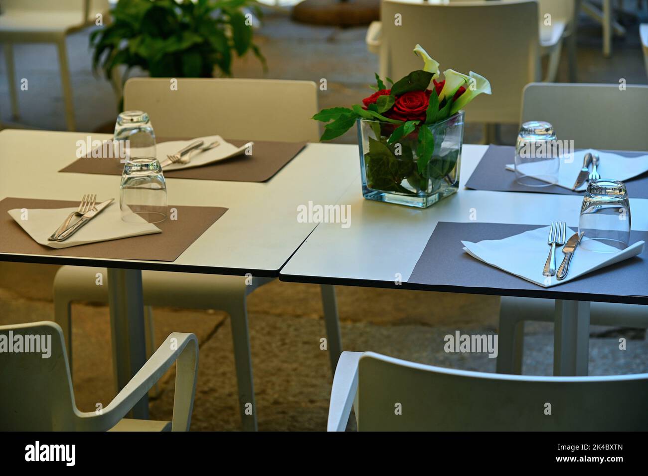 The empty restaurant tables set in the terrace waiting customers for ...