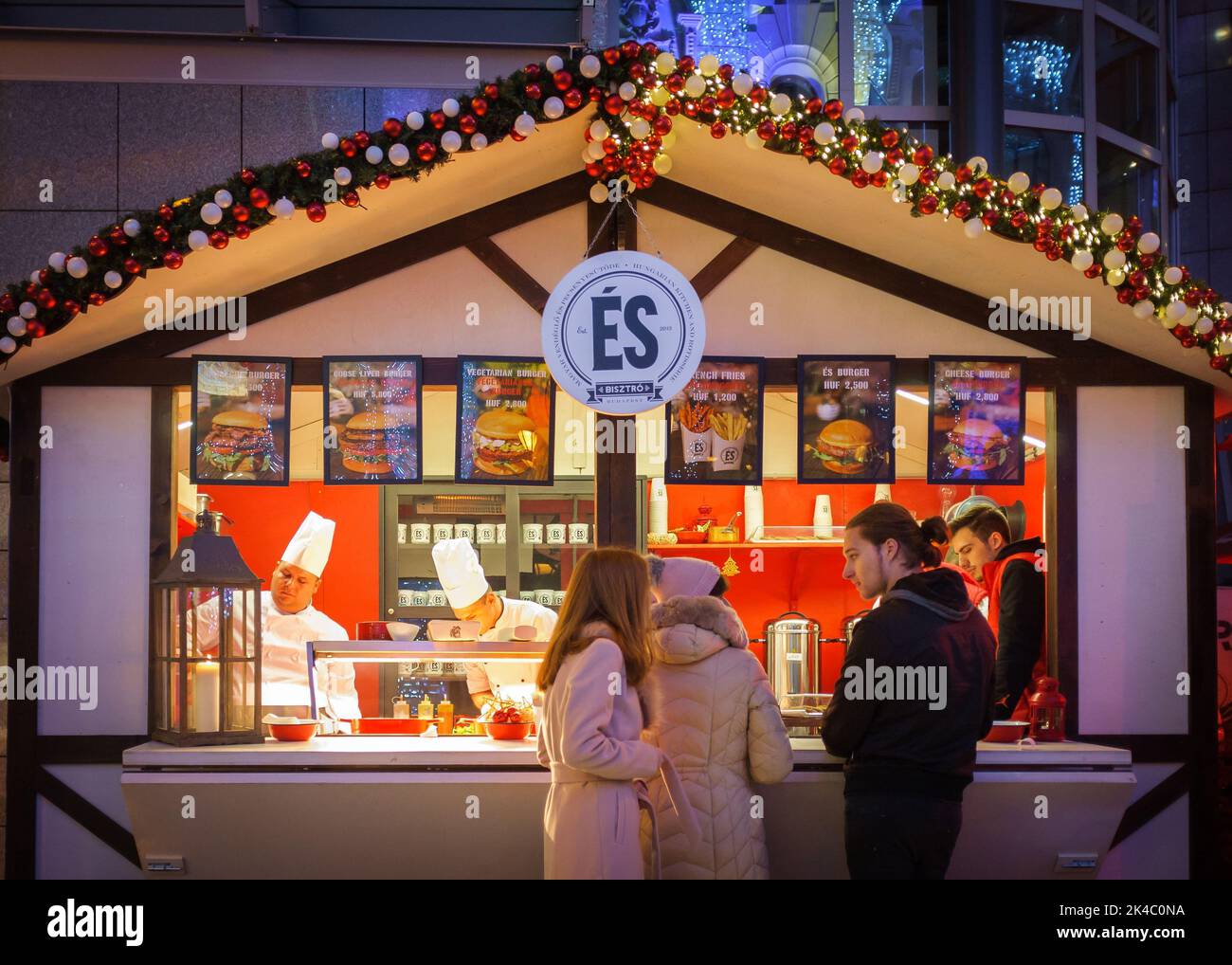 A frontal view of a burger food store with Christmas decorations as ...