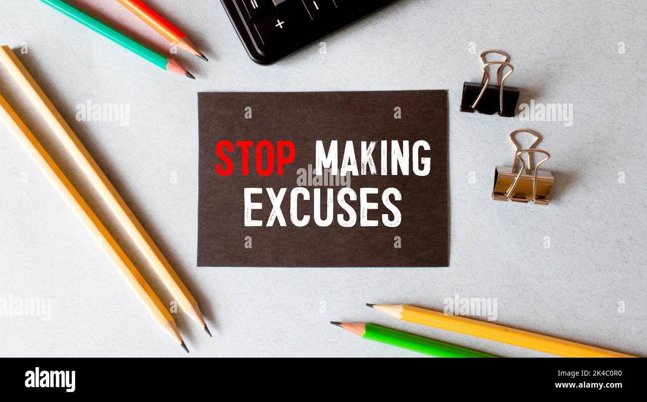 Business concept. Notebook with text STOP MAKING EXCUSES sheet of white ...
