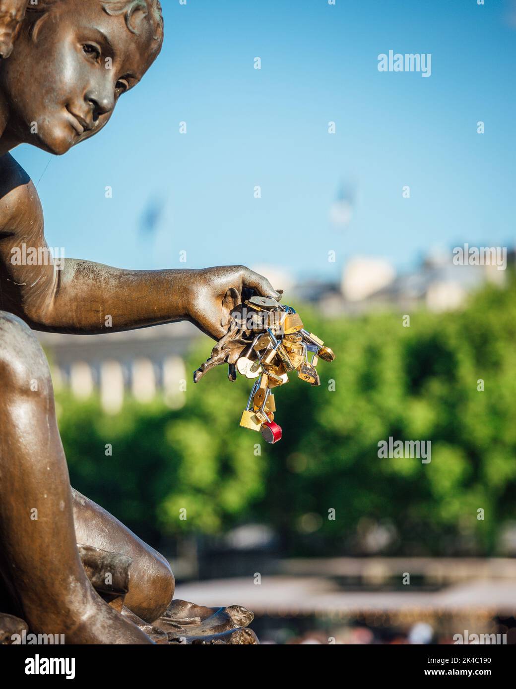 A bronze statue of an angel holding the locks and keys that lovers heng ...