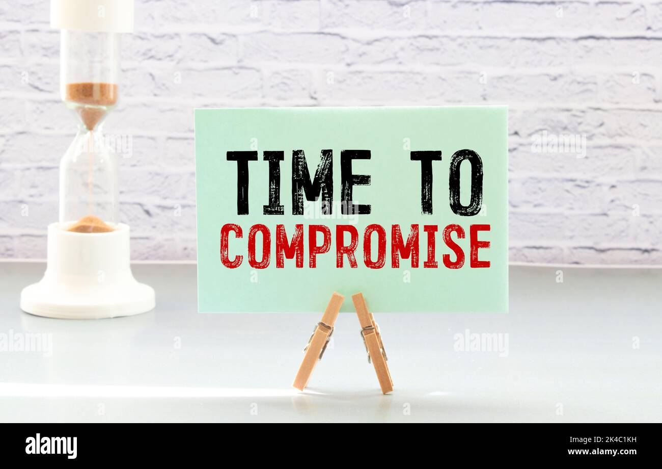 businesman hold notepad with text Time to compromise. White background ...