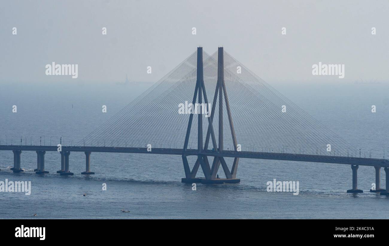 An aerial view of bridge over sea with cars driving on road in Bandra ...
