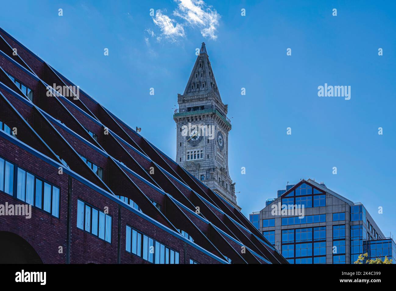 A BRICK CLOCK TOWER WITH A BRICK BUILDING IN FRONT AND A MODERN GLASS ...