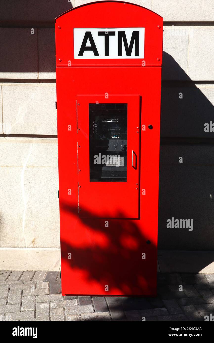 A vertical shot of red Old School Retro ATM machine Stock Photo - Alamy
