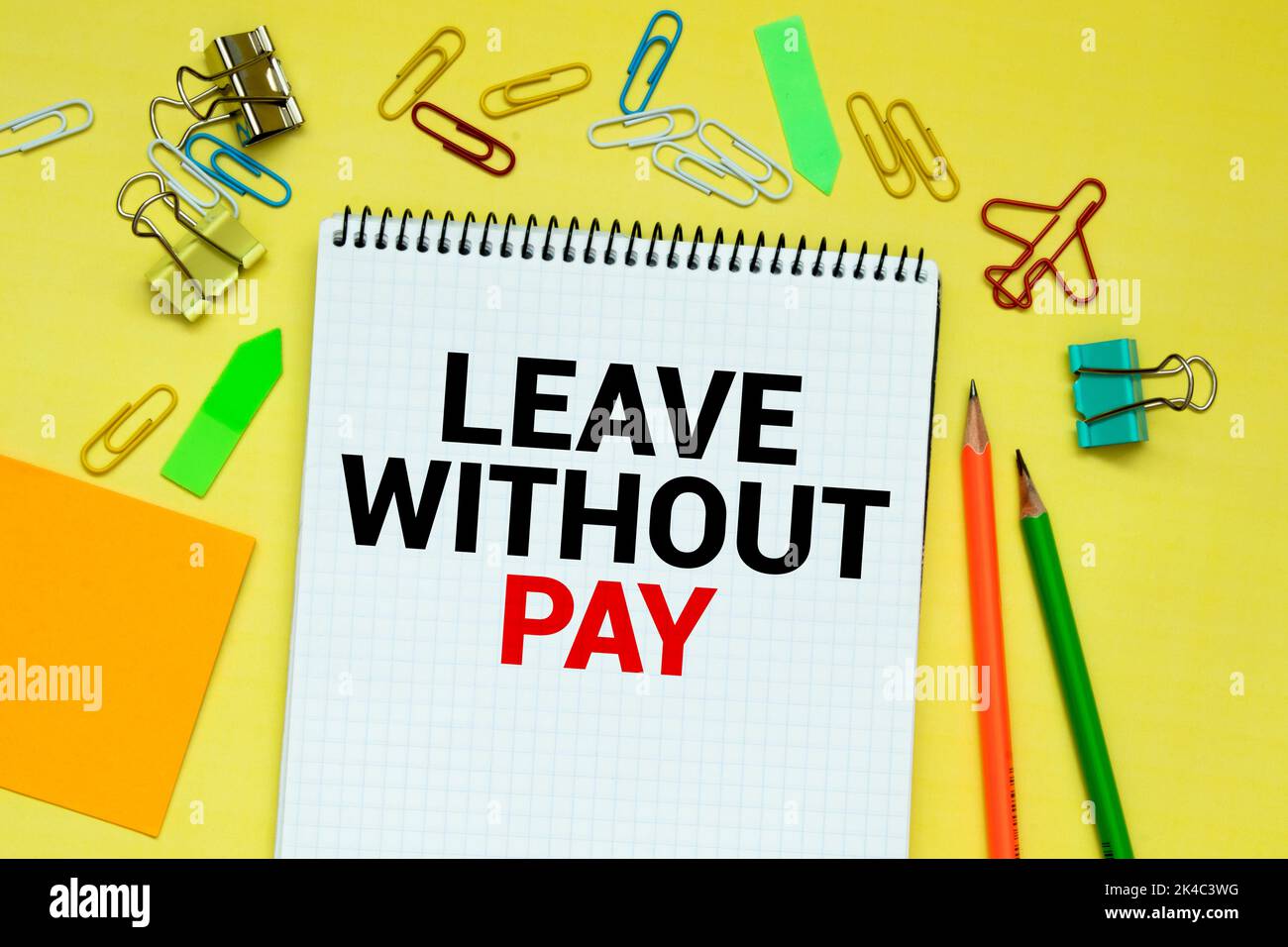 Closeup on businessman holding a card with text LEAVE WITHOUT PAY ...