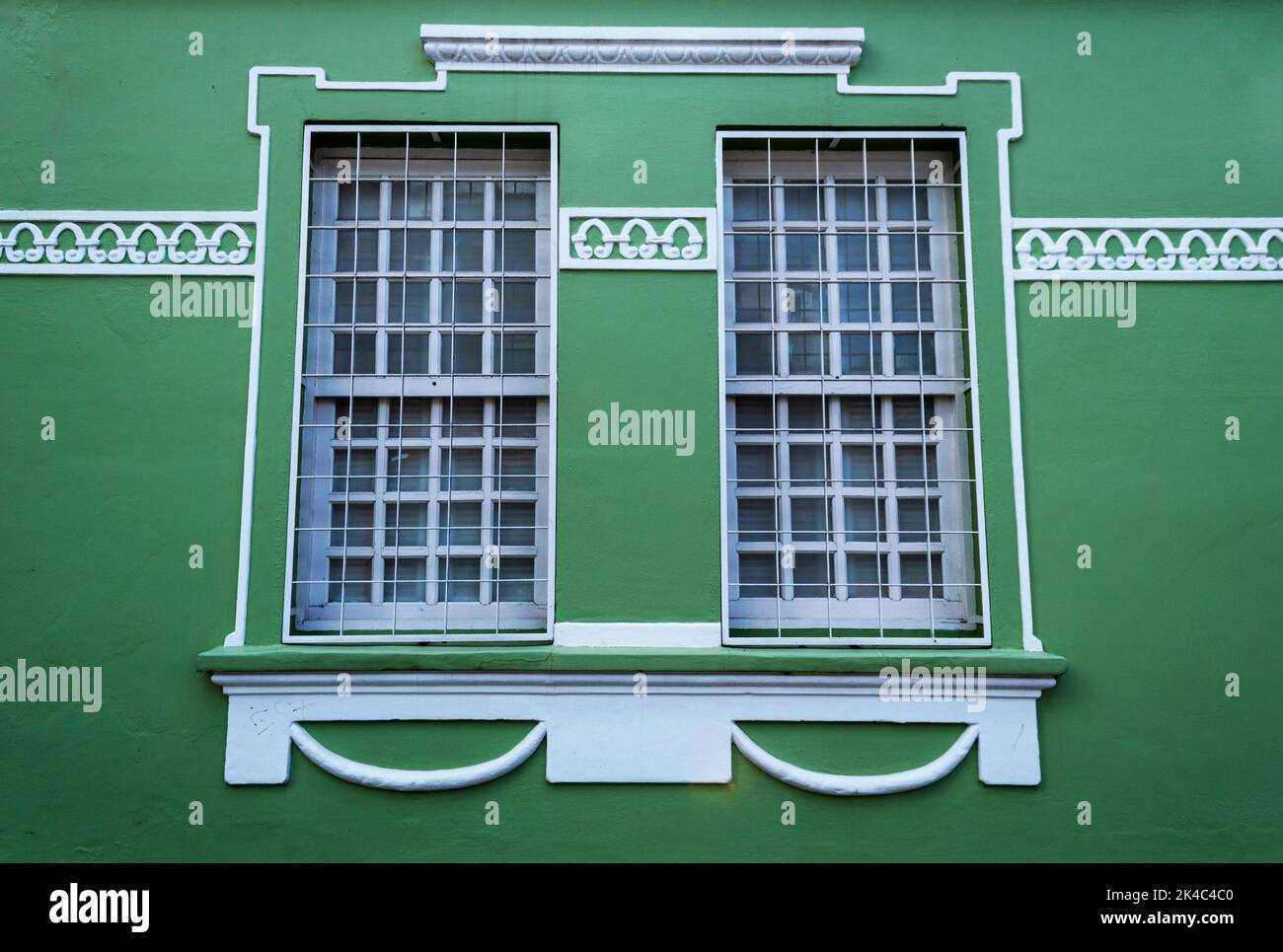 Old double windows decorated in the facade of an old house Stock Photo ...