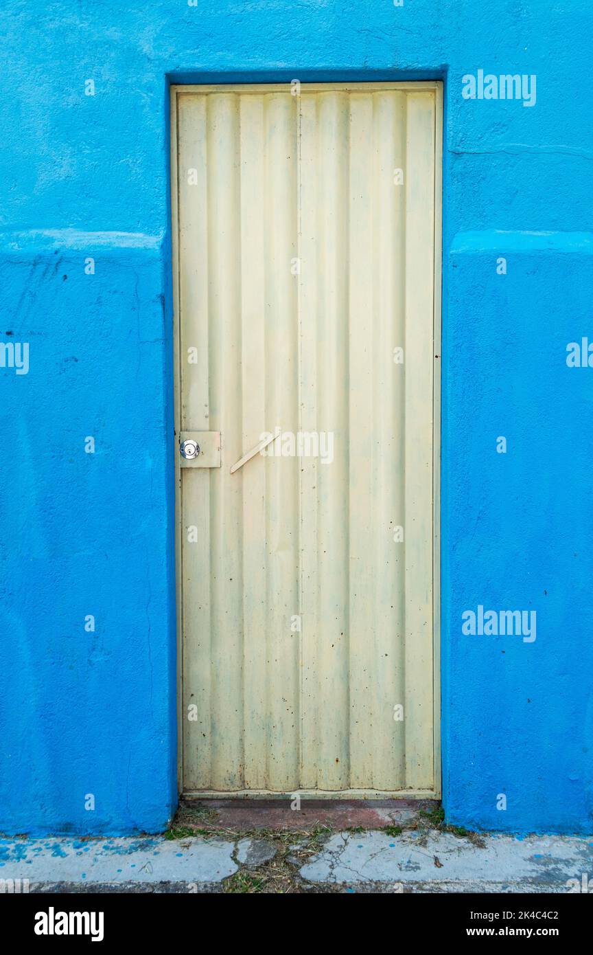 White gate in blue house facade. Blue House Facade with Beige Metal ...