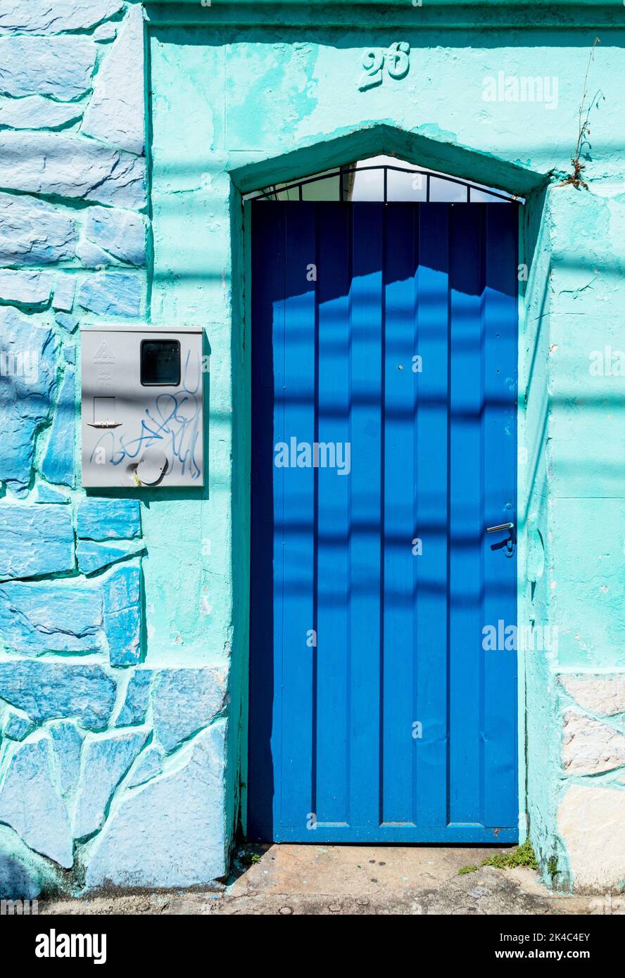 Blue house facade with mailbox. Blue metal door in a house with blue ...