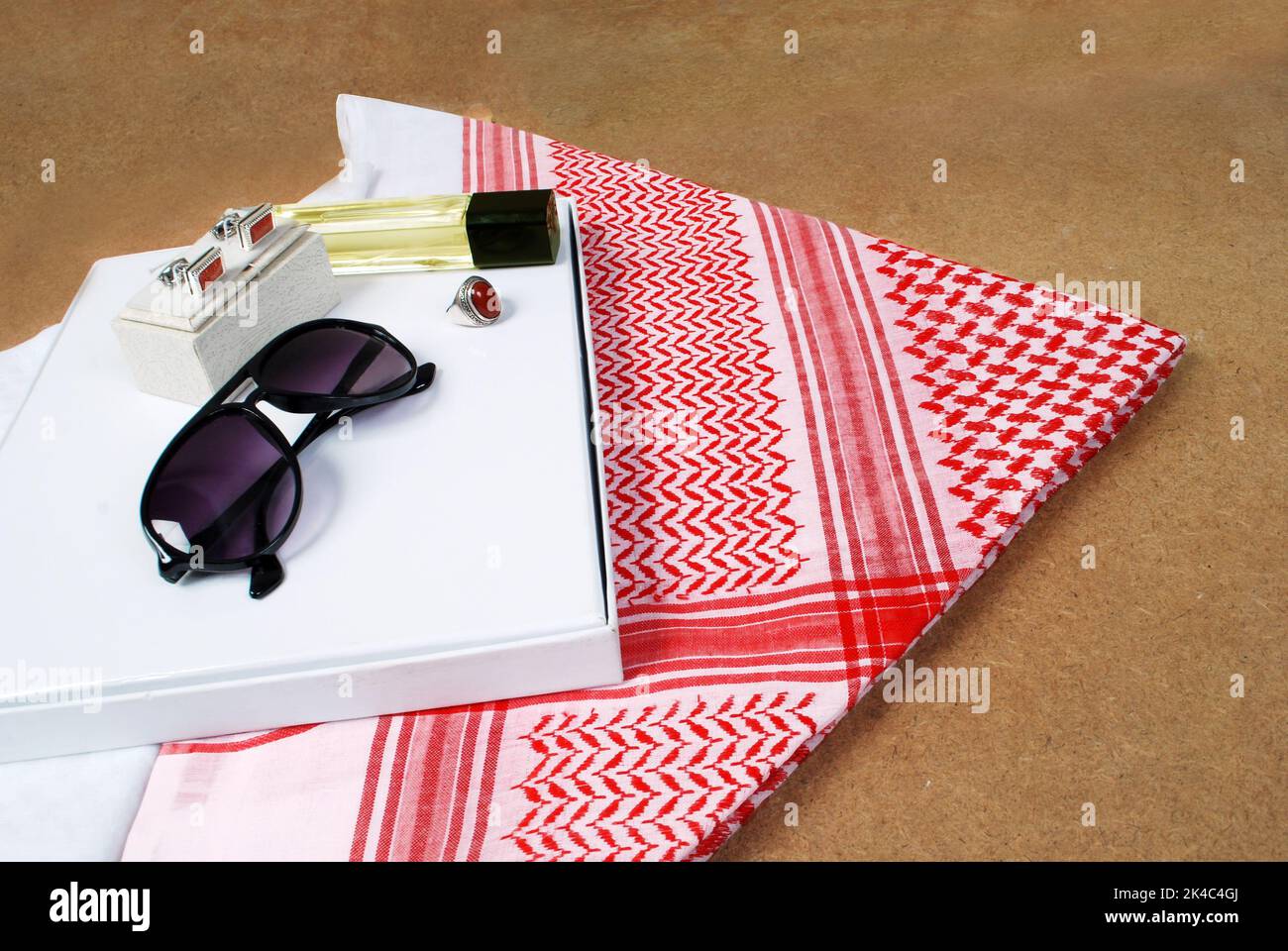 Saudi red shemagh headscarf with luxury accessories glasses perfume ...