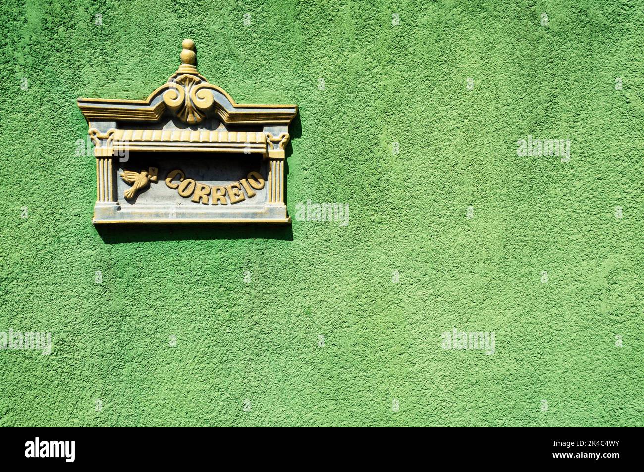 Mailbox gold. Horizontal. Mailbox in green house facade Stock Photo - Alamy