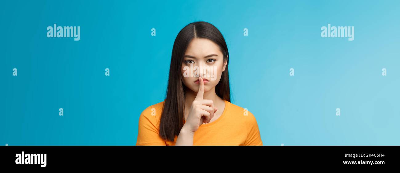Hush stay silent. Serious-looking asian girl look displeased grumpy ...